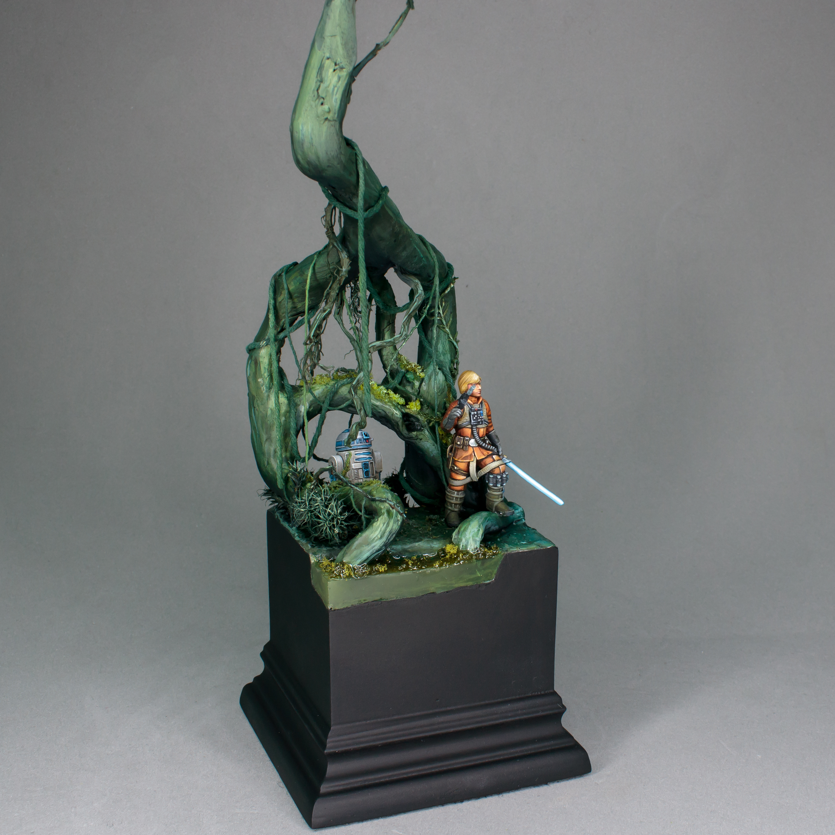 Figure of Luke Skywalker and R2-D2 in Dagobah swamp.